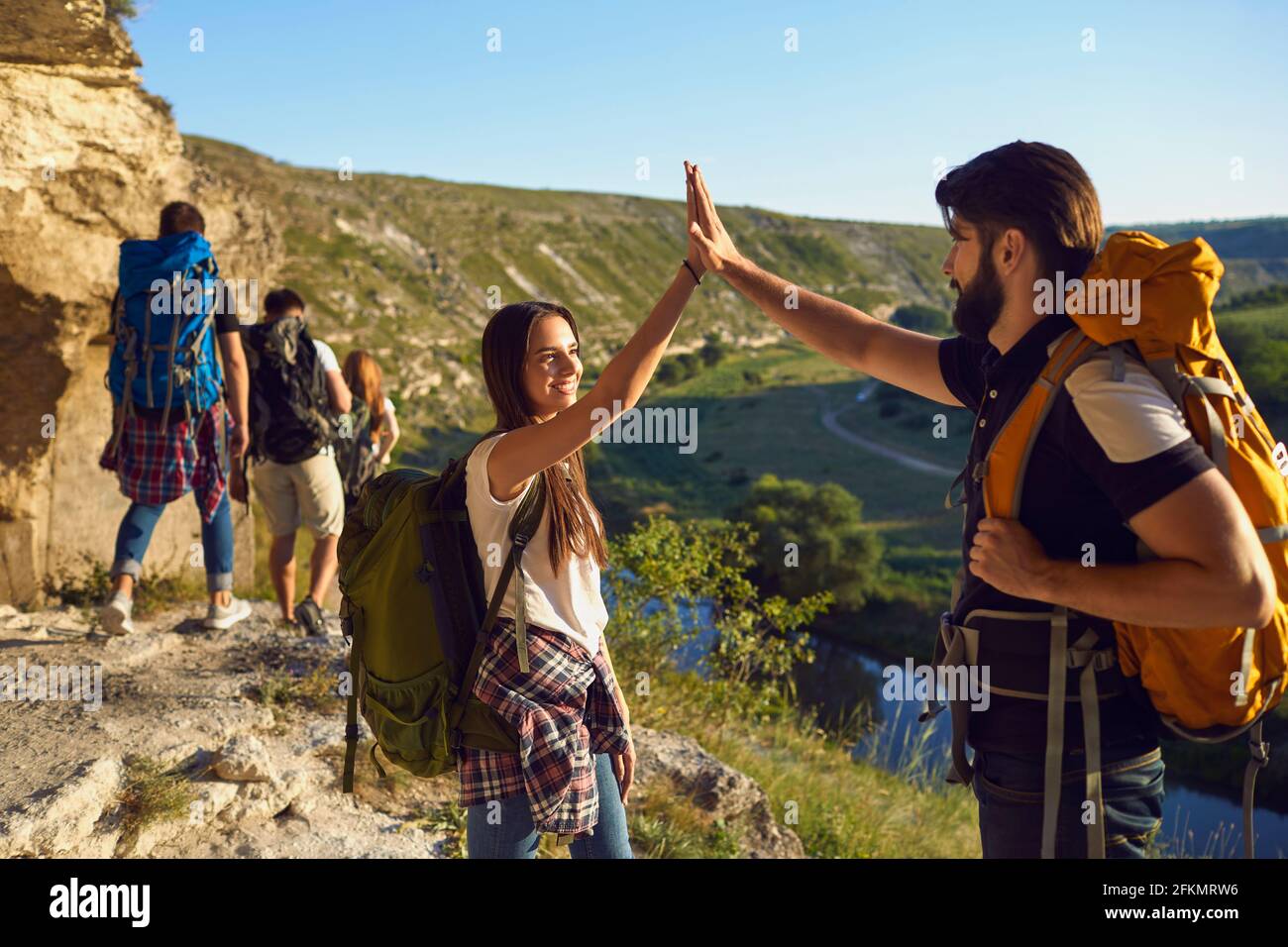 Travelers giving high five to each other Stock Photo - Alamy
