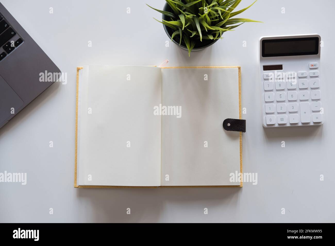 Modern white office desk table with calculator and laptop computer ...