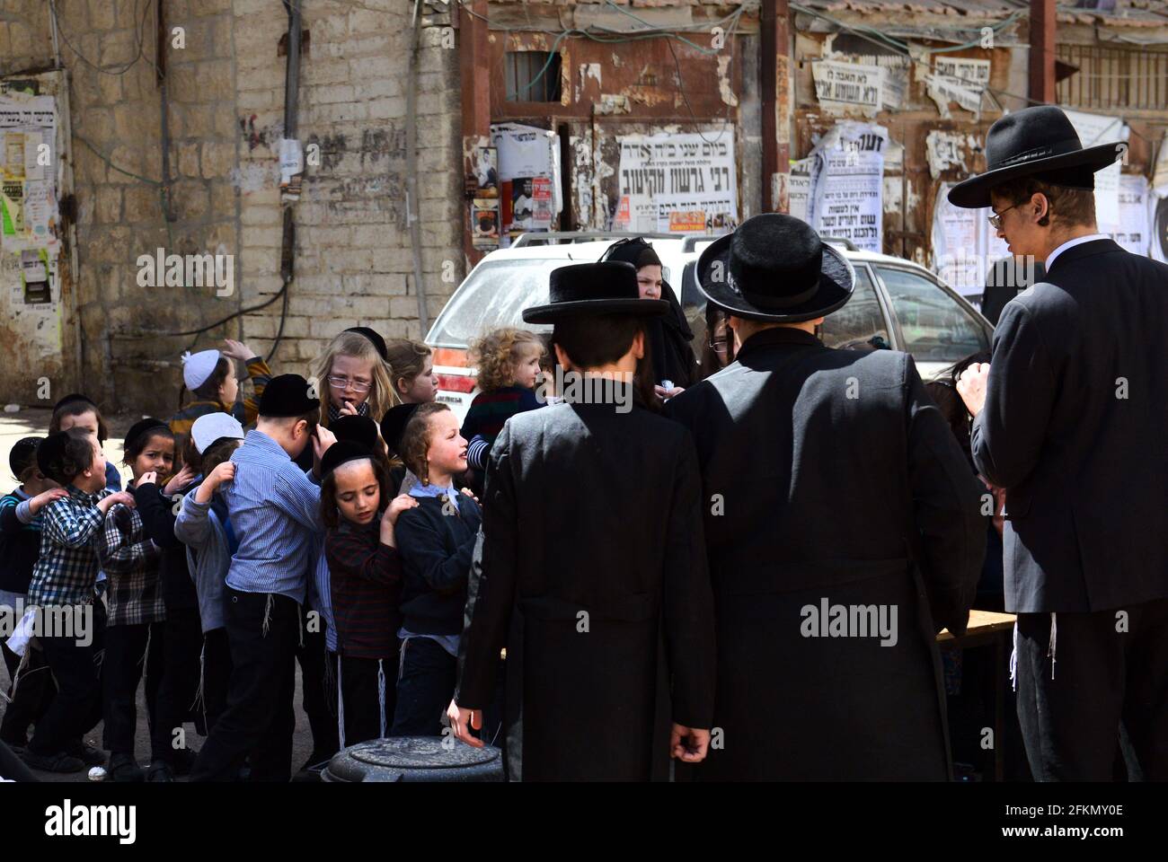 Jewish Orthodox children waiting in line for food and sweets served by ...