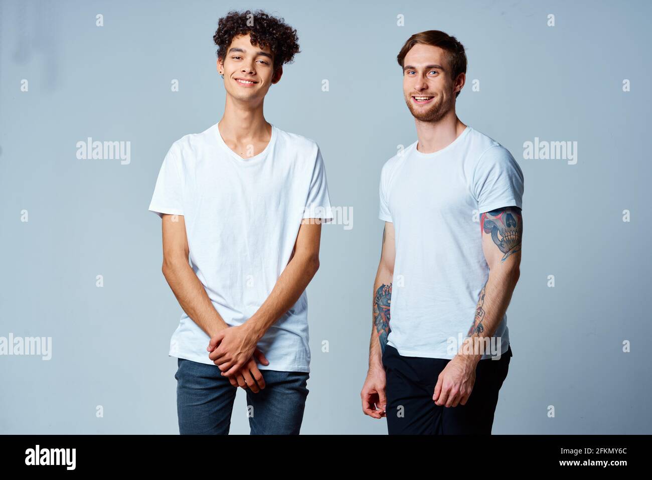 Two young friends wearing t shirts hi-res stock photography and images ...