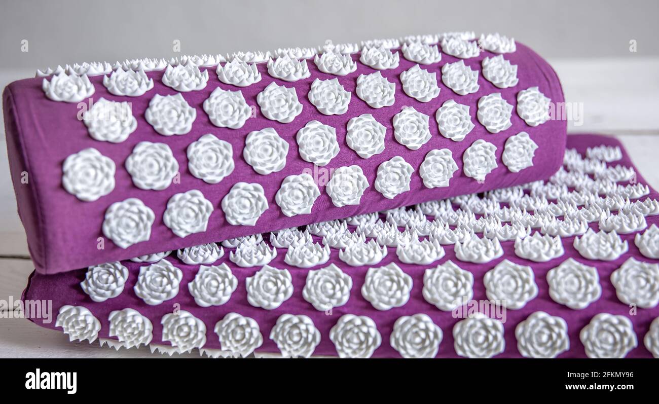 Close up massage acupuncture mat with pillow and white massage tips ...