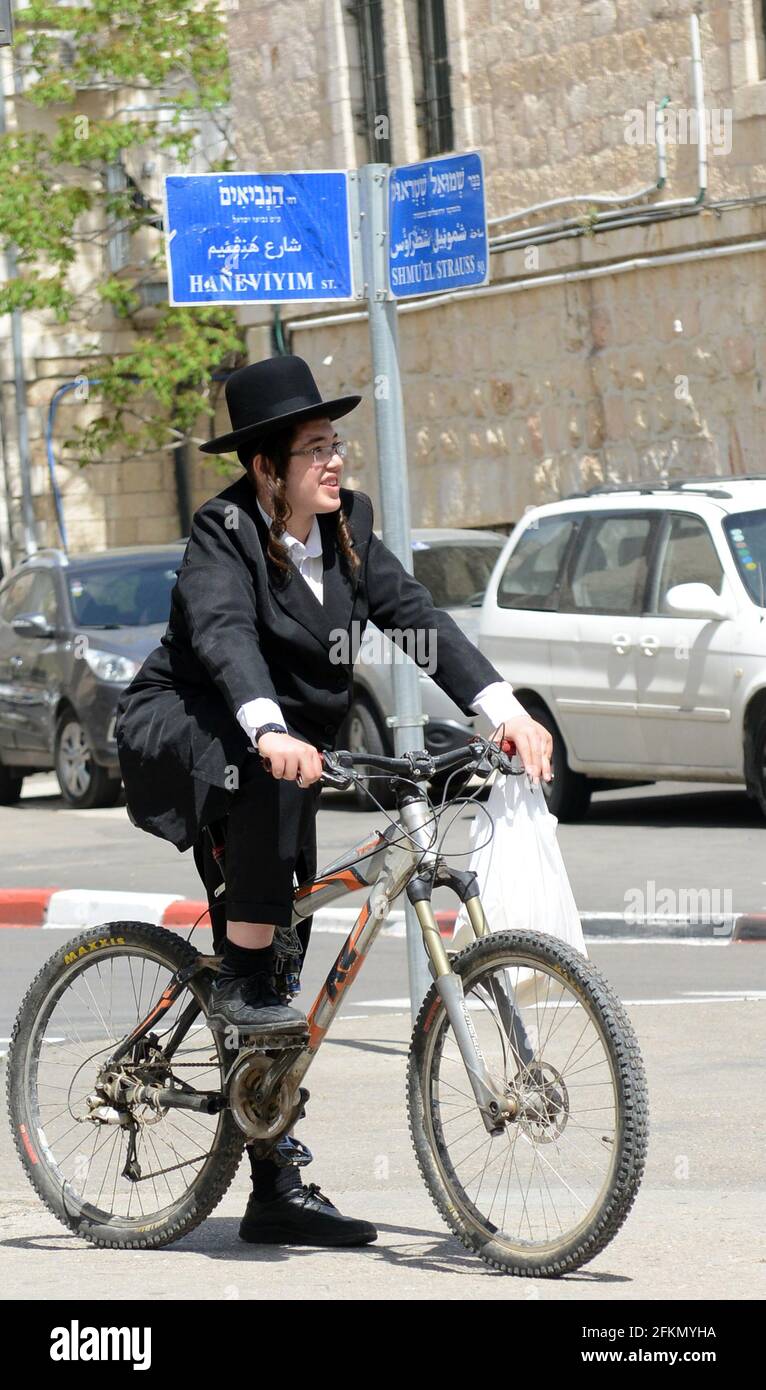 A Jewish Yeshiva boy riding his bicycle in Jerusalem, Israel Stock ...