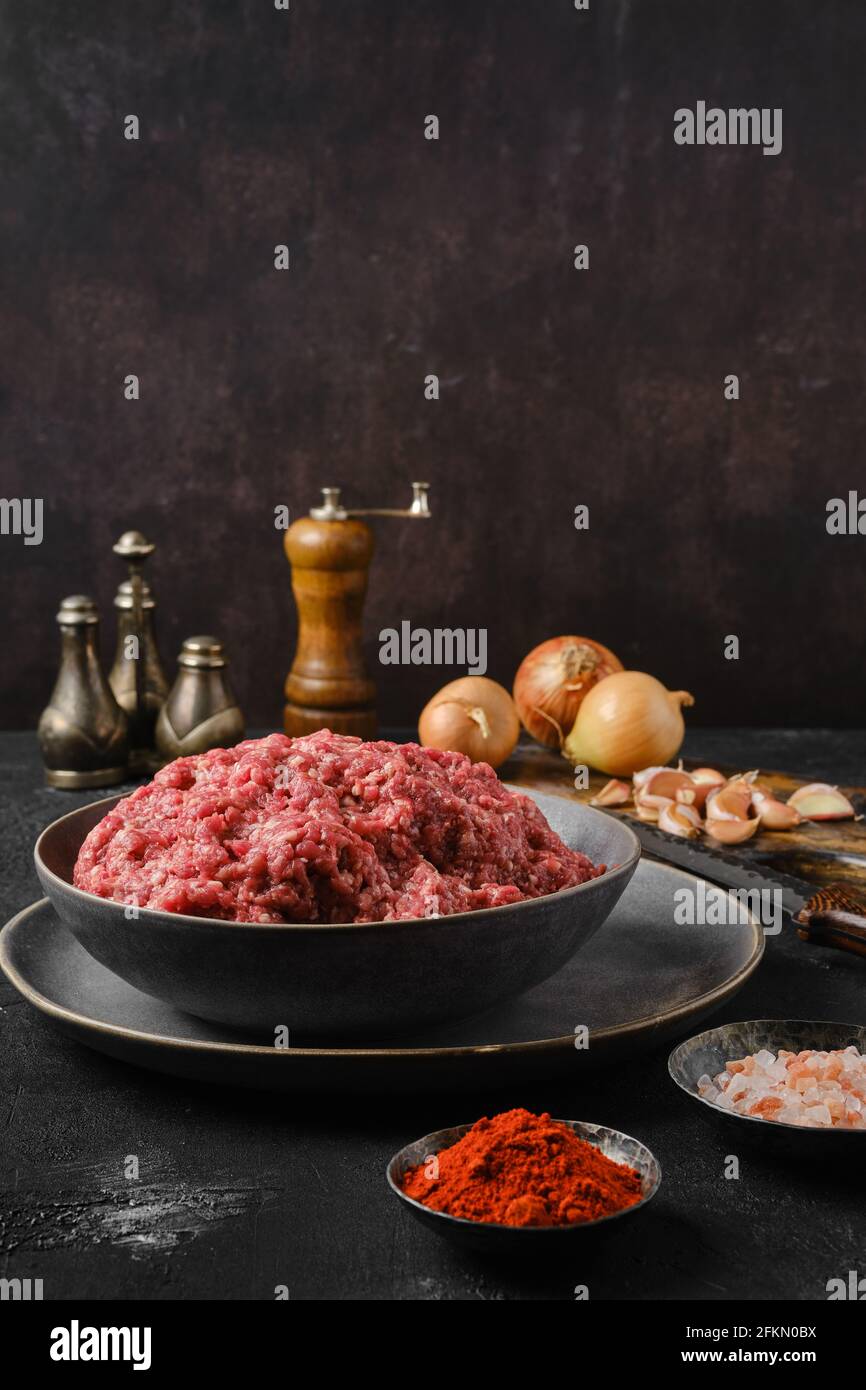 Raw ground beef forcemeat in a bowl on dark background Stock Photo - Alamy