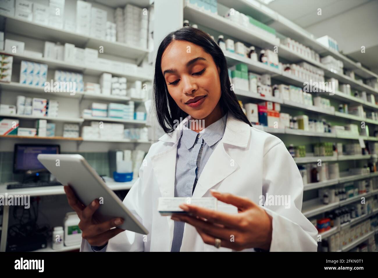 Pharmacist checking medication details hi-res stock photography and ...