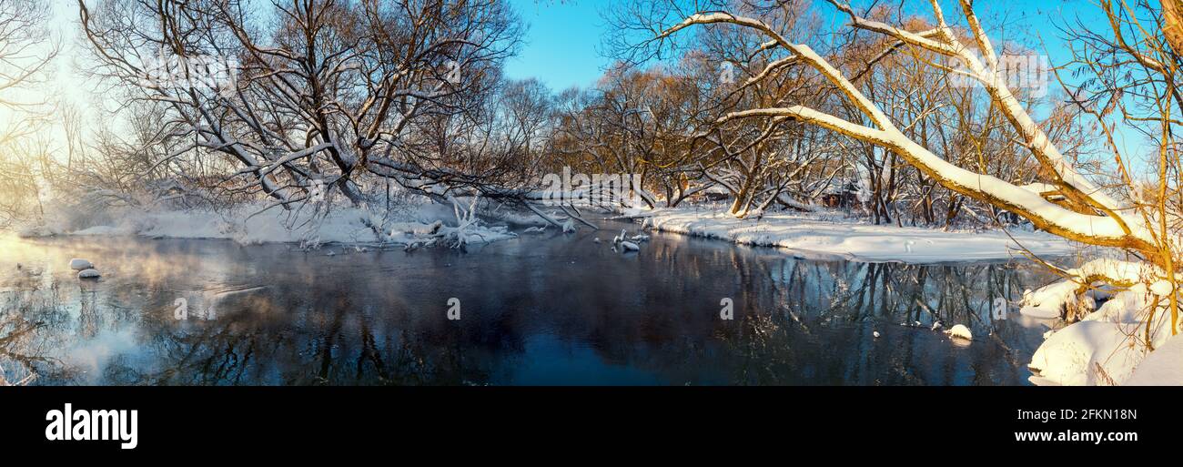 Frosty winter panoramic landscape with forest river during sunny ...