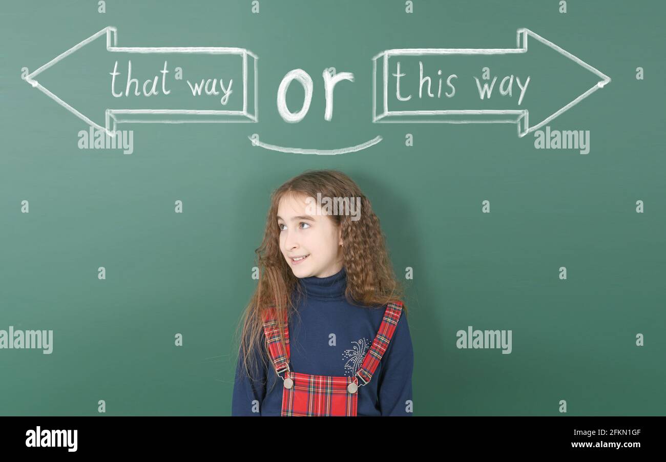 Pre-adolescent girl thinks about which way to choose, left or right ...