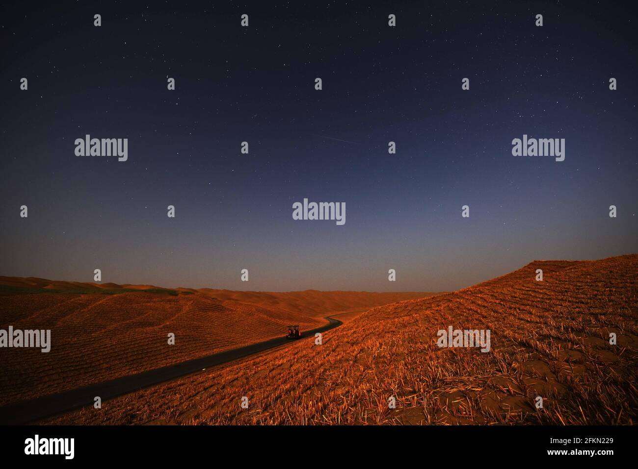XINJIANG, CHINA - MAY 1, 2021 - Starry skies are seen above a road ...