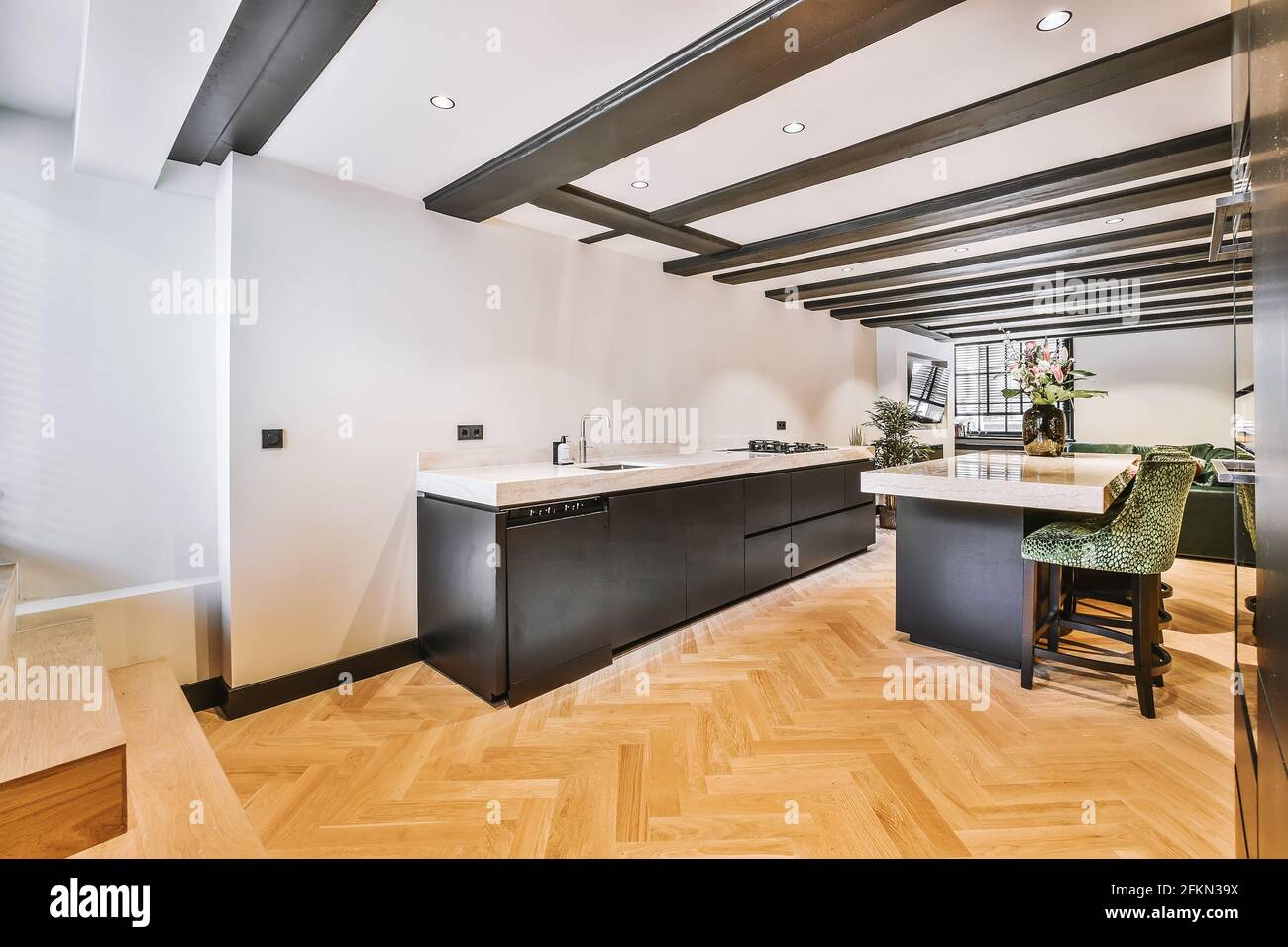 Open plan spacious kitchen with ceiling beams Stock Photo - Alamy