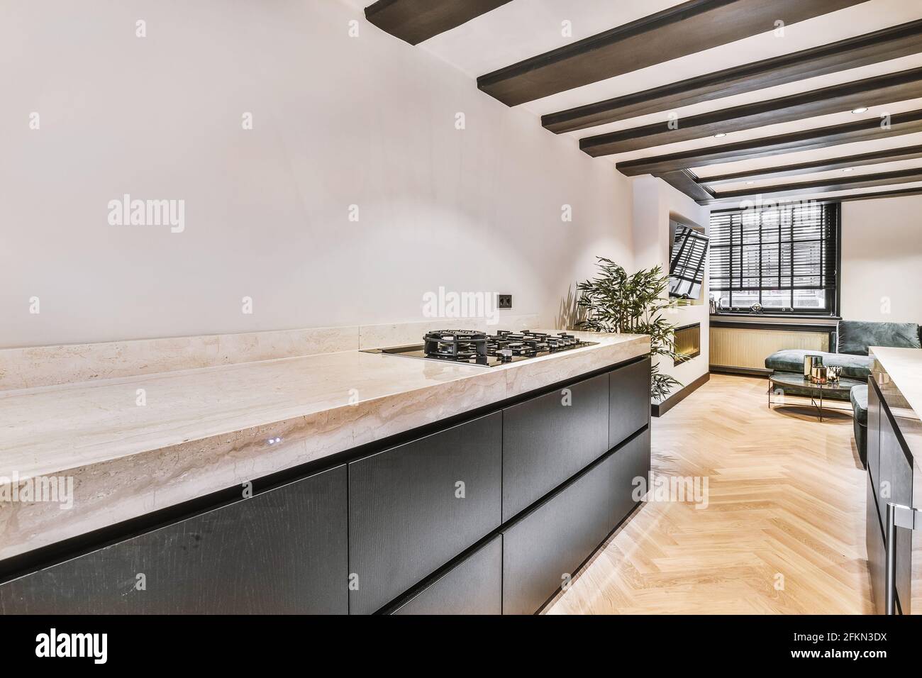 Open plan spacious kitchen with ceiling beams Stock Photo - Alamy
