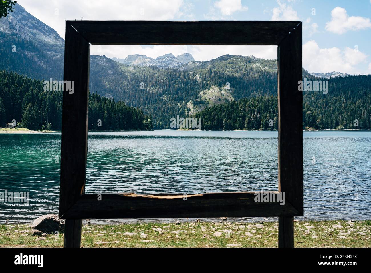 Picturesque view of the lake through the wooden frame Stock Photo - Alamy