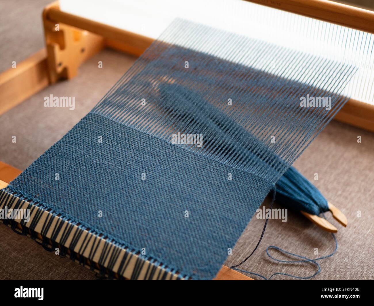 Creation of the textile using a weaving loom Stock Photo - Alamy