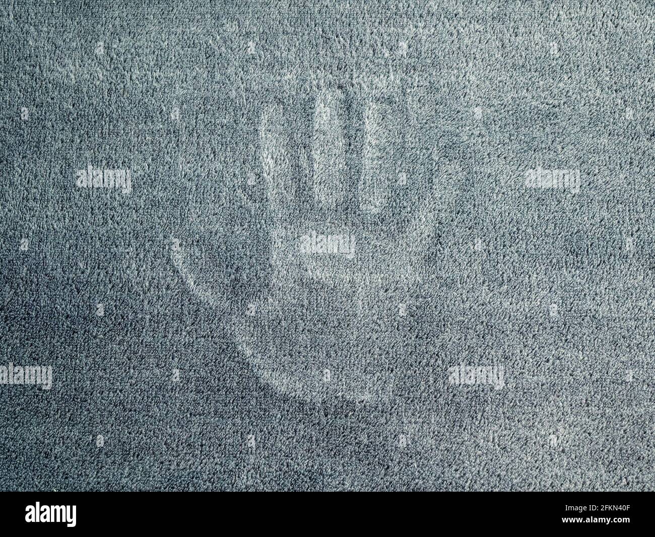 Mark of the hand on the grey velour textured surface. Palm silhouette ...