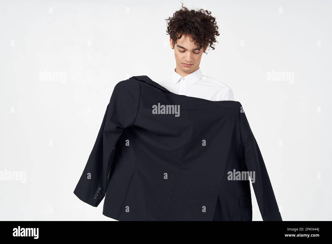 man holding a black jacket in his hands fashion modern style self ...