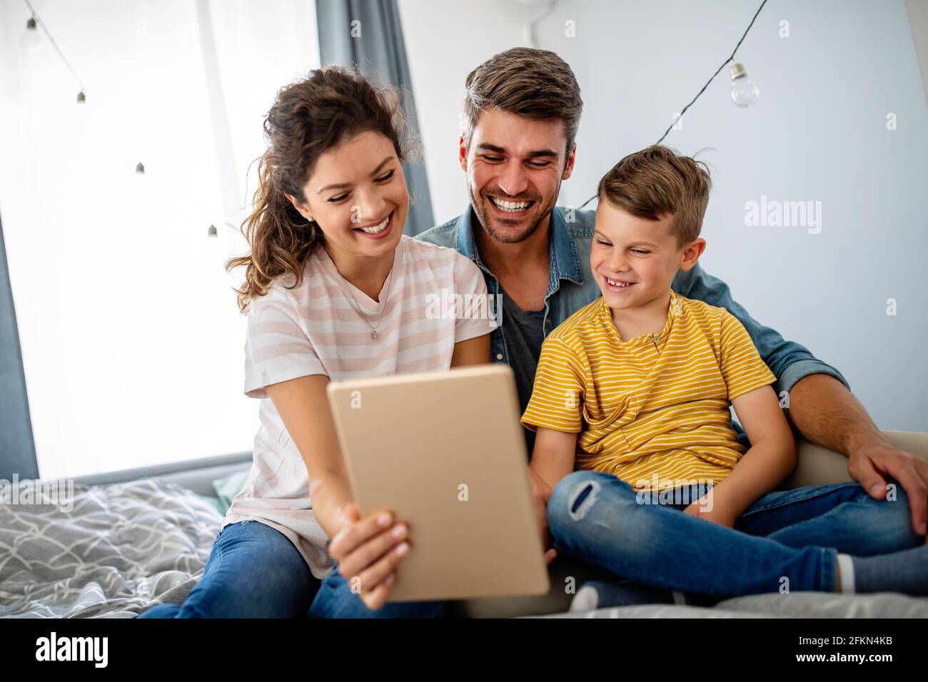 Happy family using technology devices together at home Stock Photo - Alamy