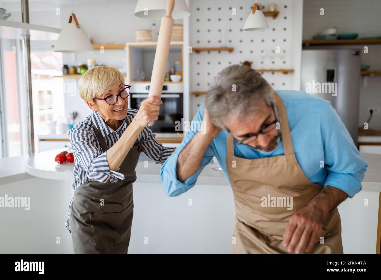 Family quarrel. Upset, scared senior man against angry woman at home ...