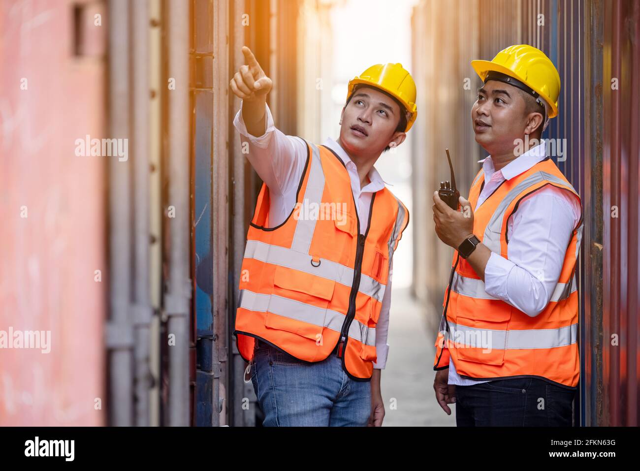Two factory workers or engineers looking and pointing something in ...
