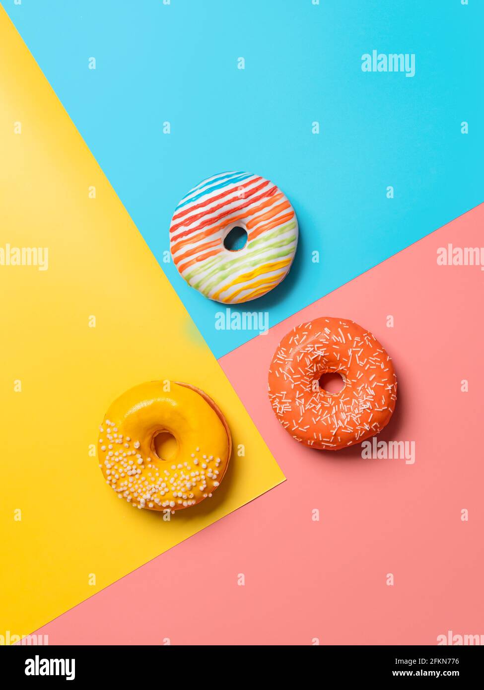 Creative layout made from delicious glazed donuts. Vertical flat lay ...