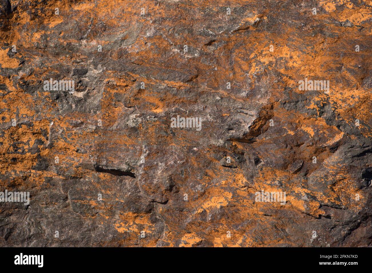Chipped rock with orange inclusions and impurities. Background Stock ...
