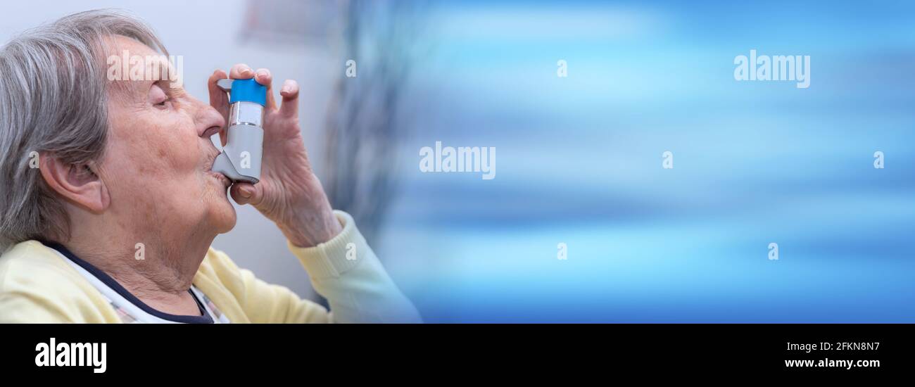 Elderly woman using an asthma inhaler; panoramic banner Stock Photo - Alamy