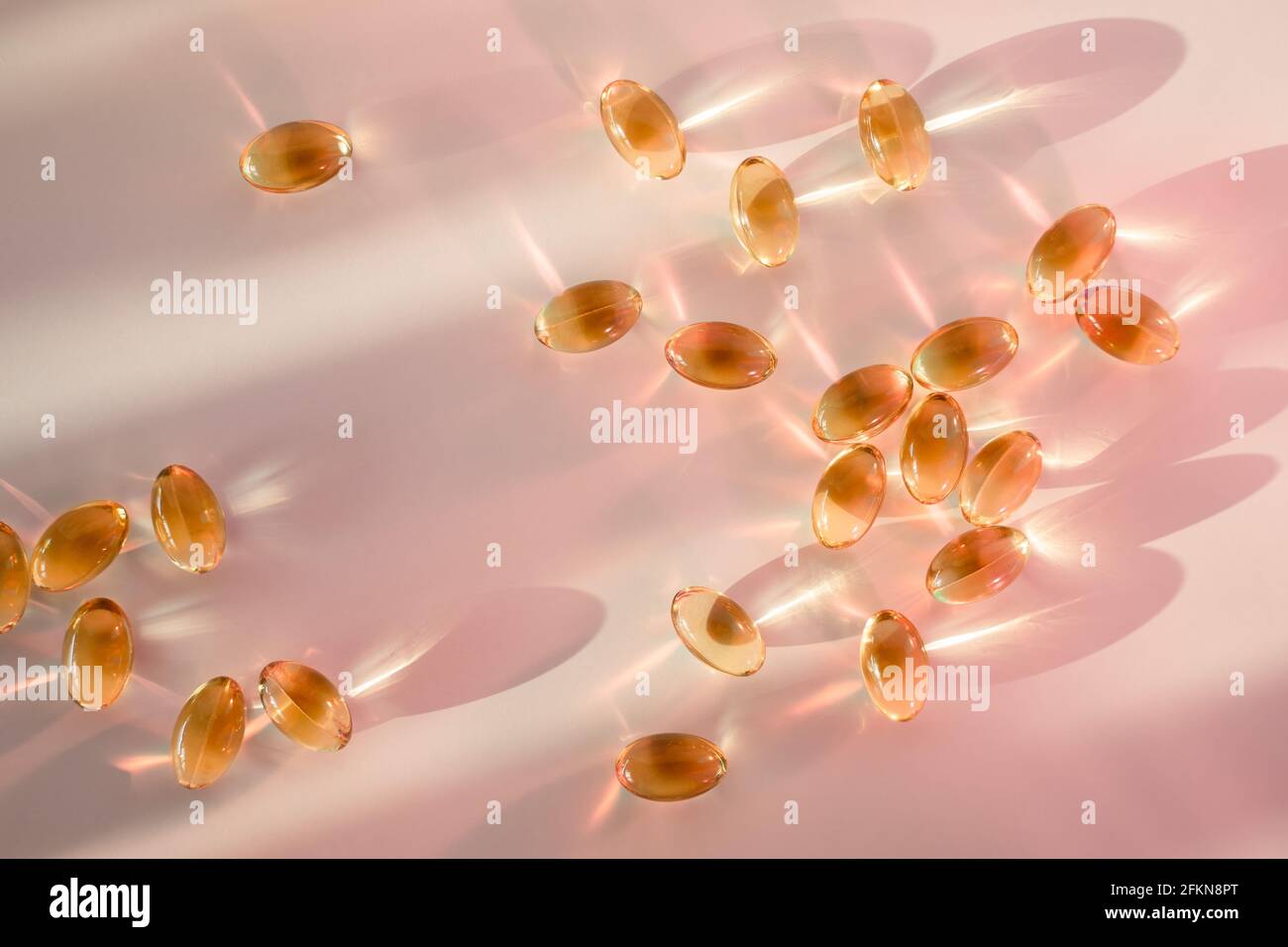 beauty capsules with light reflexes on pink and blue background Stock ...