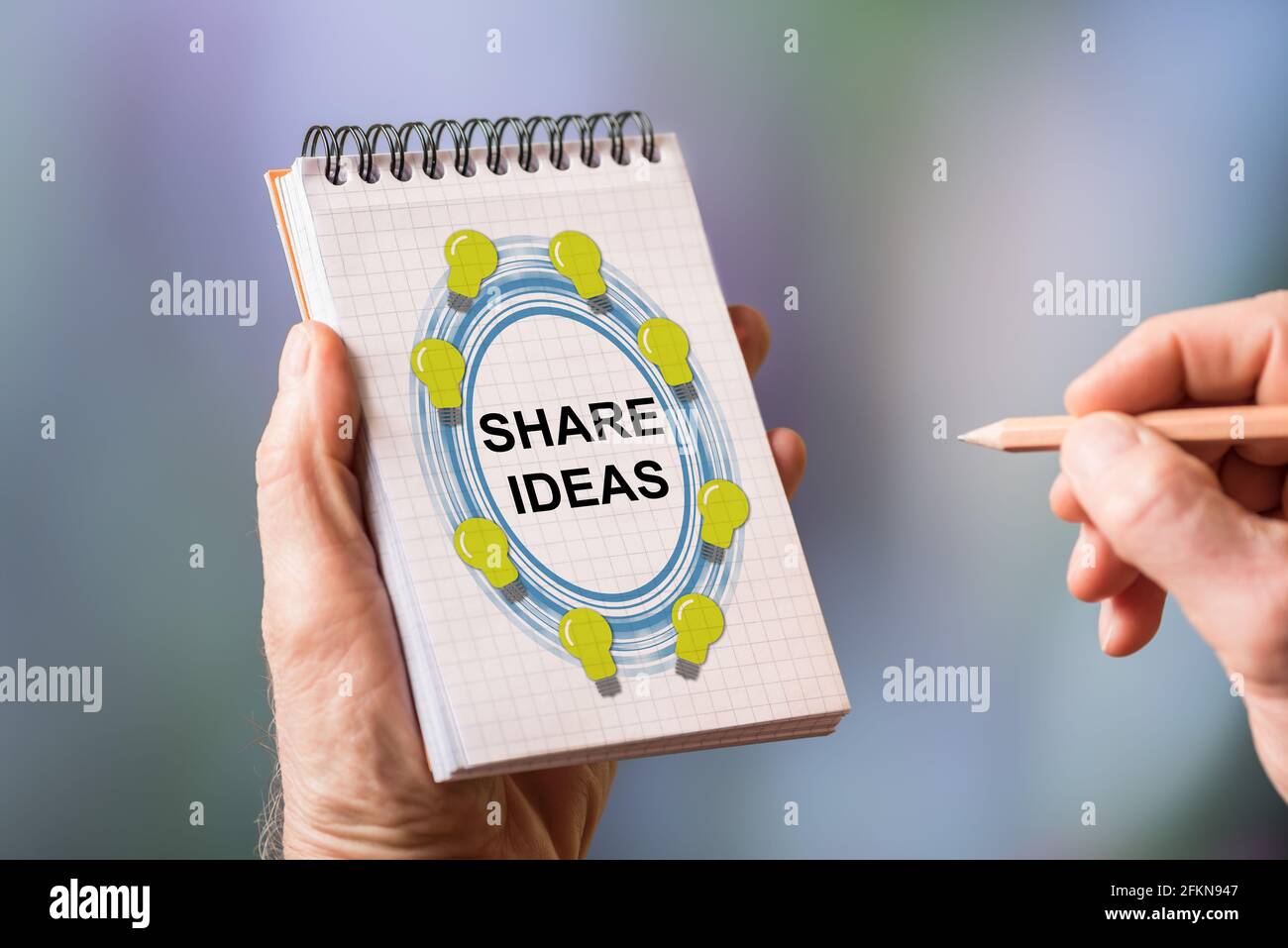 Hand drawing share ideas concept on a notepad Stock Photo - Alamy