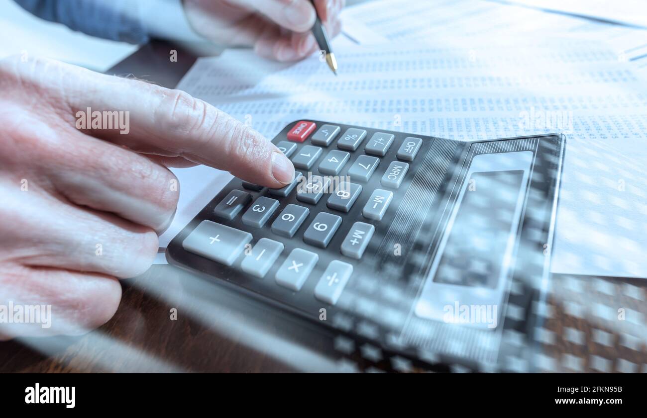 Man with calculator doing his accounting; multiple exposure Stock Photo ...
