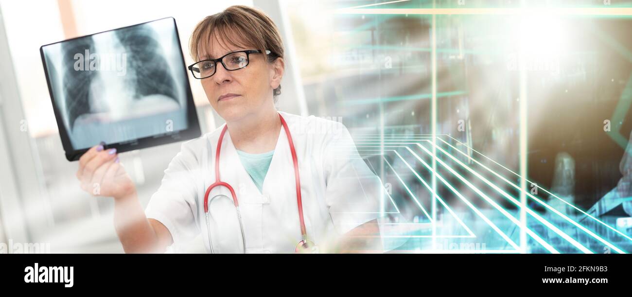 Female doctor looking at x-ray in clinic; multiple exposure Stock Photo ...