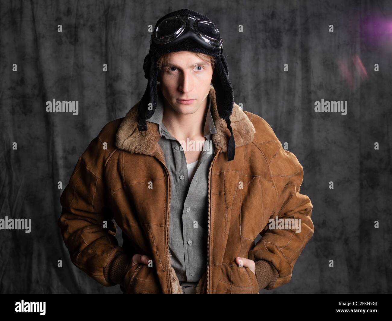 Pilot aviator in retro style, a young man in a flight jacket and ...