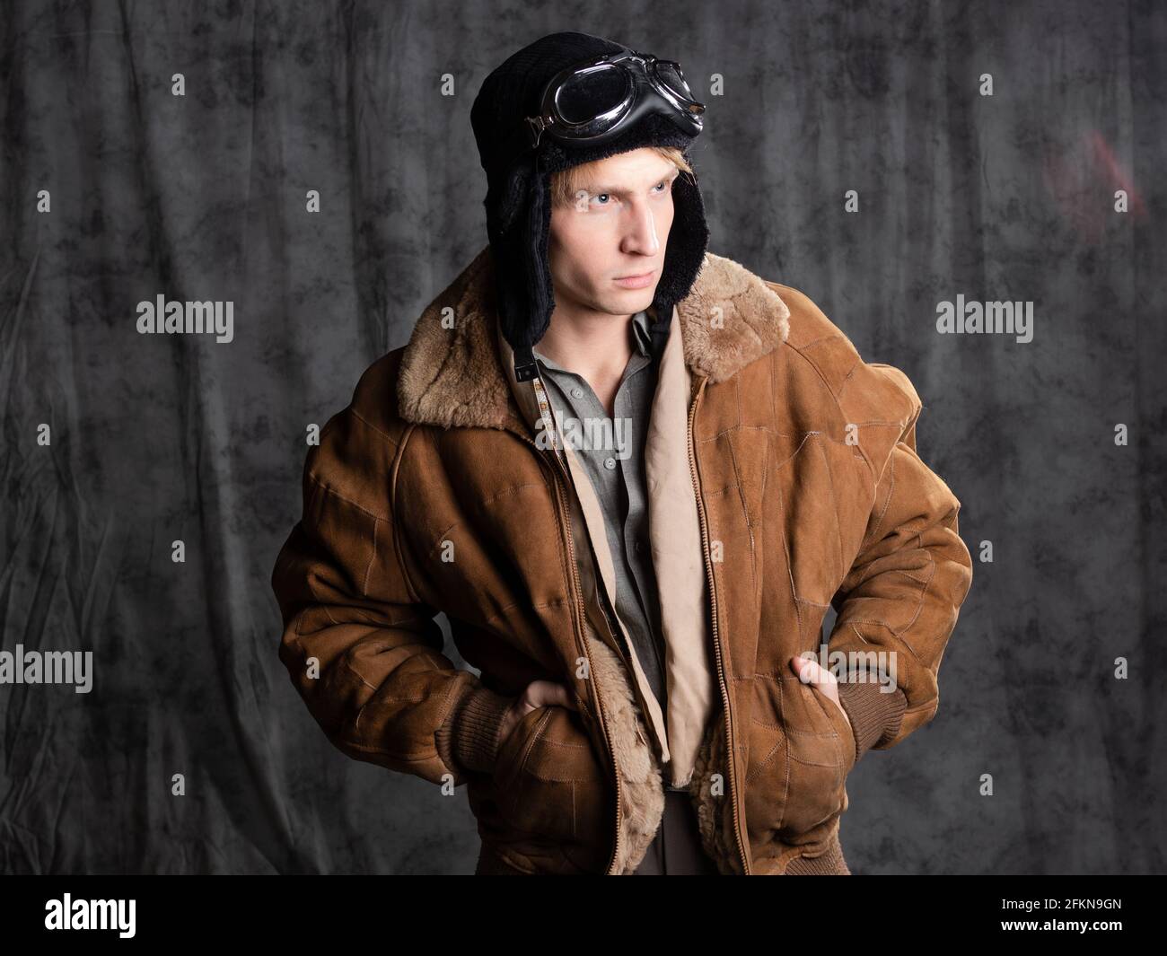 Retro style aviator in a flying hat with goggles. Young attractive man ...