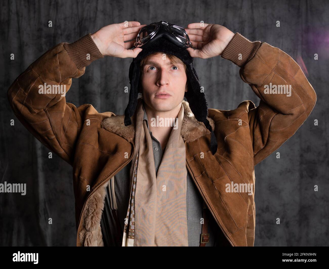 The dreamer. Retro style aviator in a flying hat with goggles, looking ...