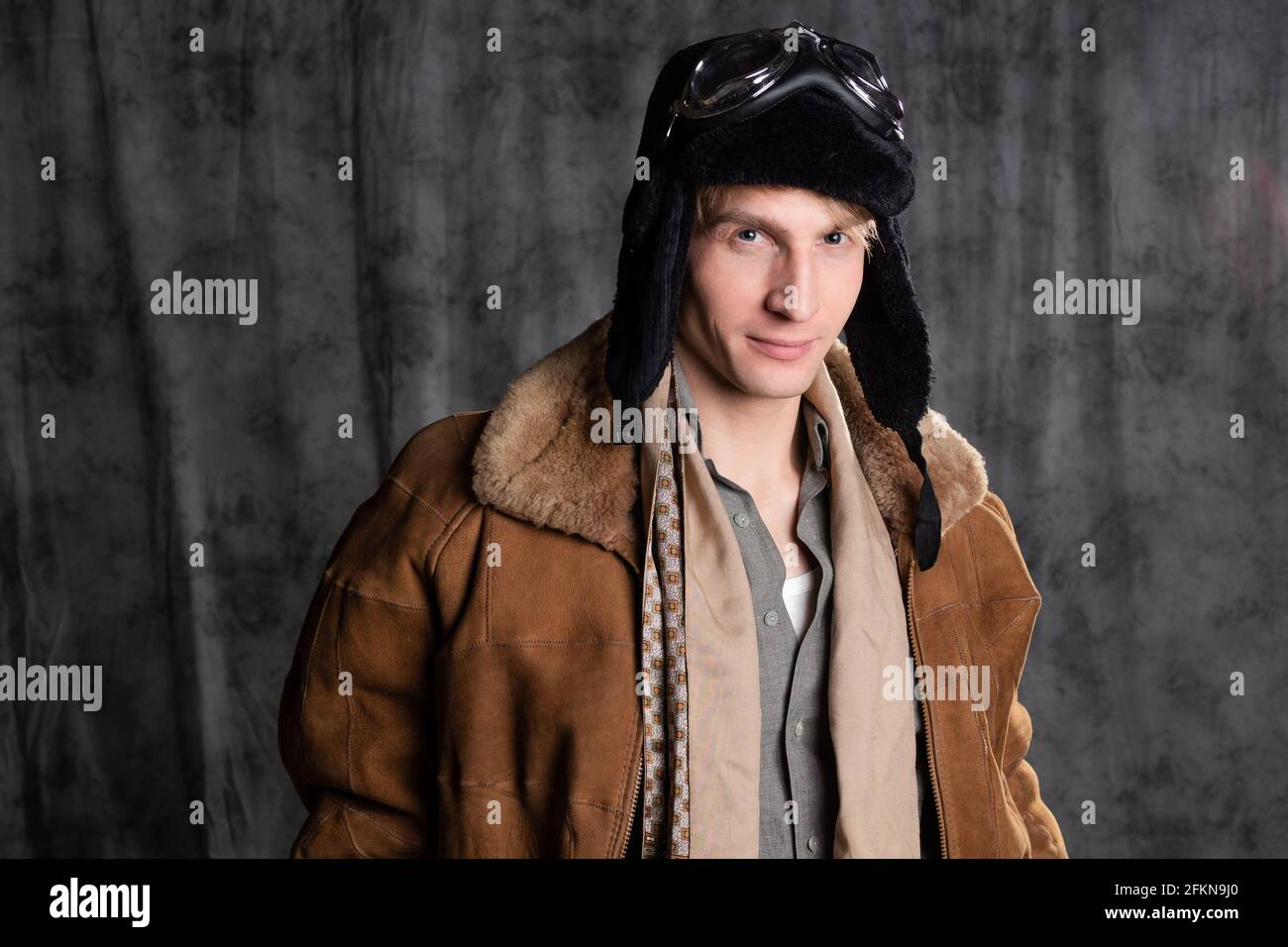 Pilot aviator in retro style, a young man in a flight jacket and ...