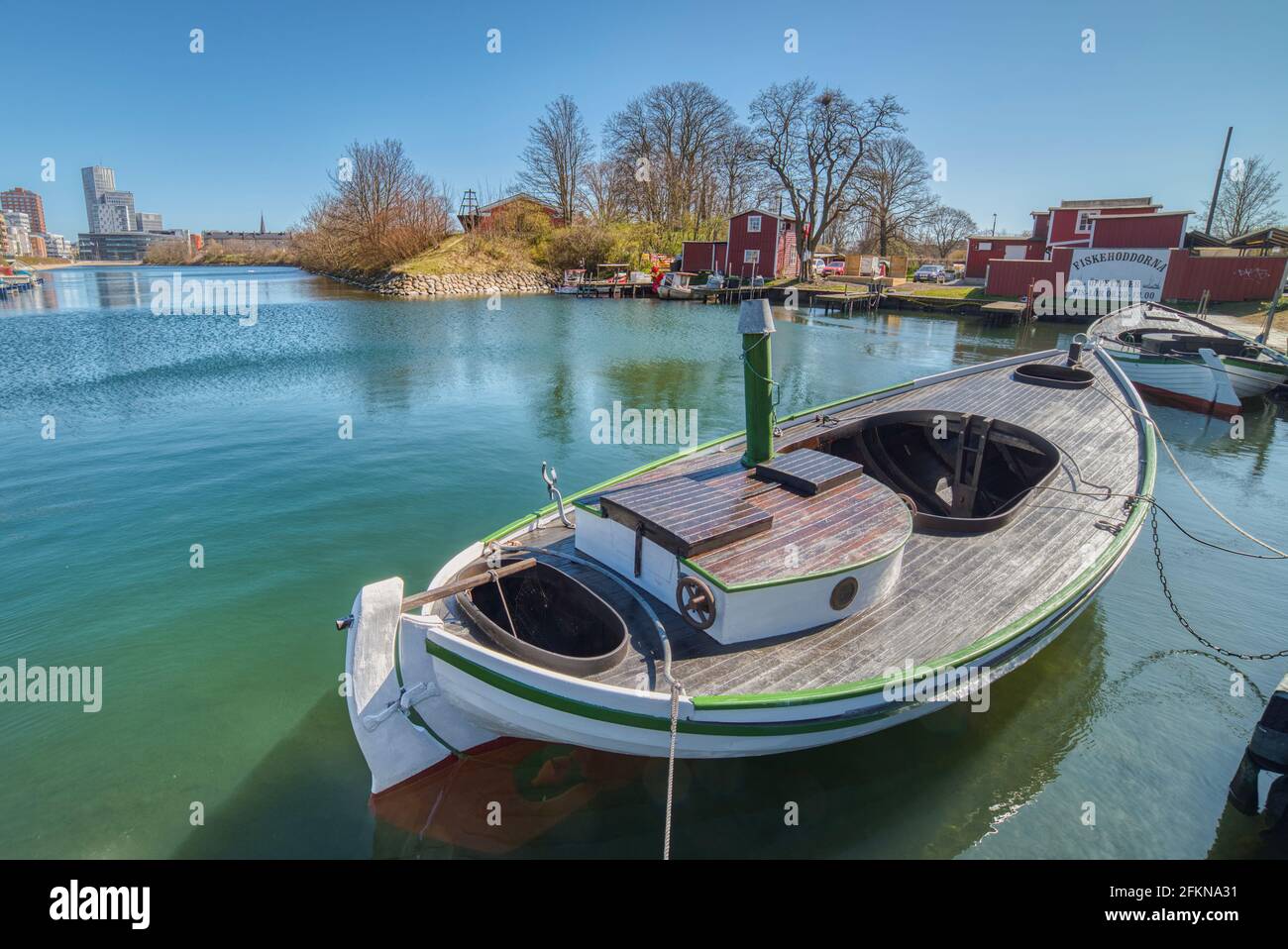 Traditional Swedish wooden boat (Gozzo) mooring at sea nearby a typical ...
