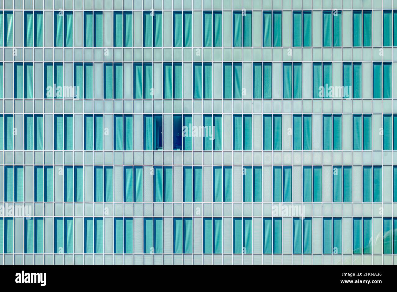 Windows pattern on cyan modern skyscraper or glazed office facade ...