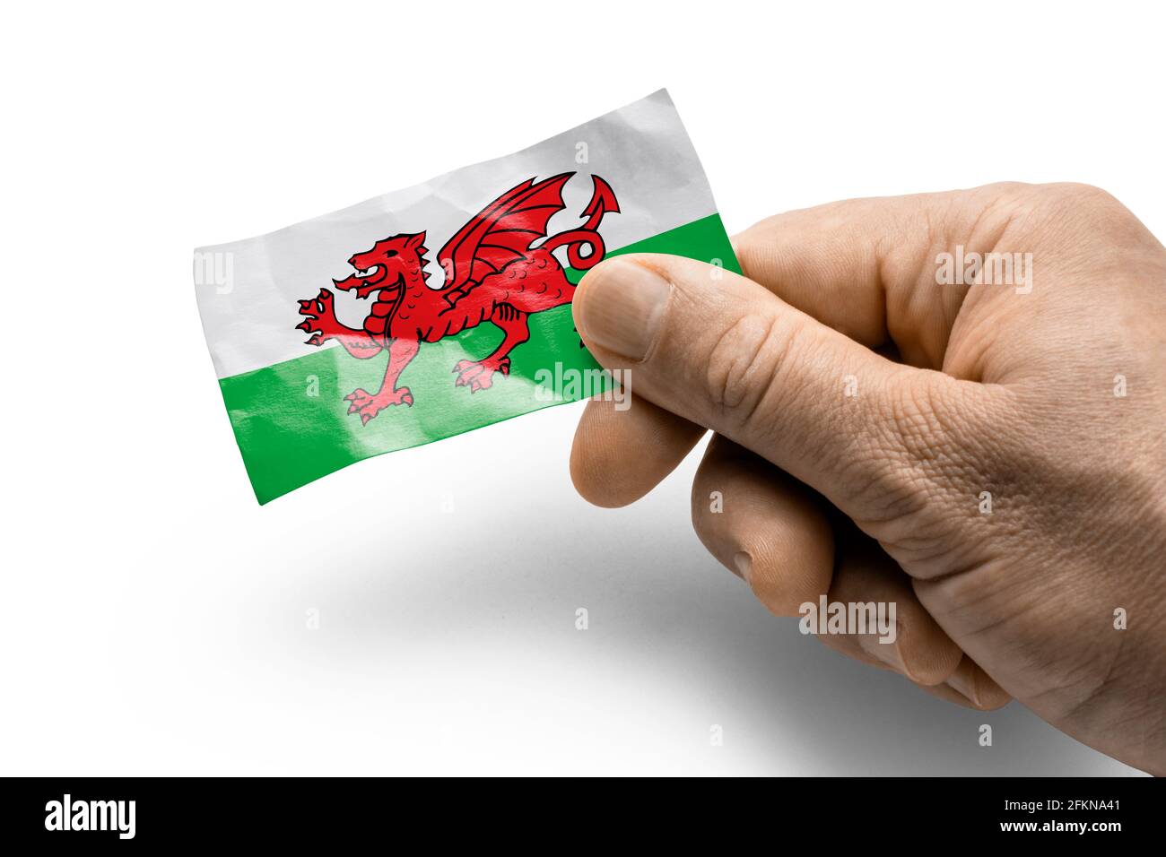 Hand holding a card with a national flag the Wales Stock Photo - Alamy