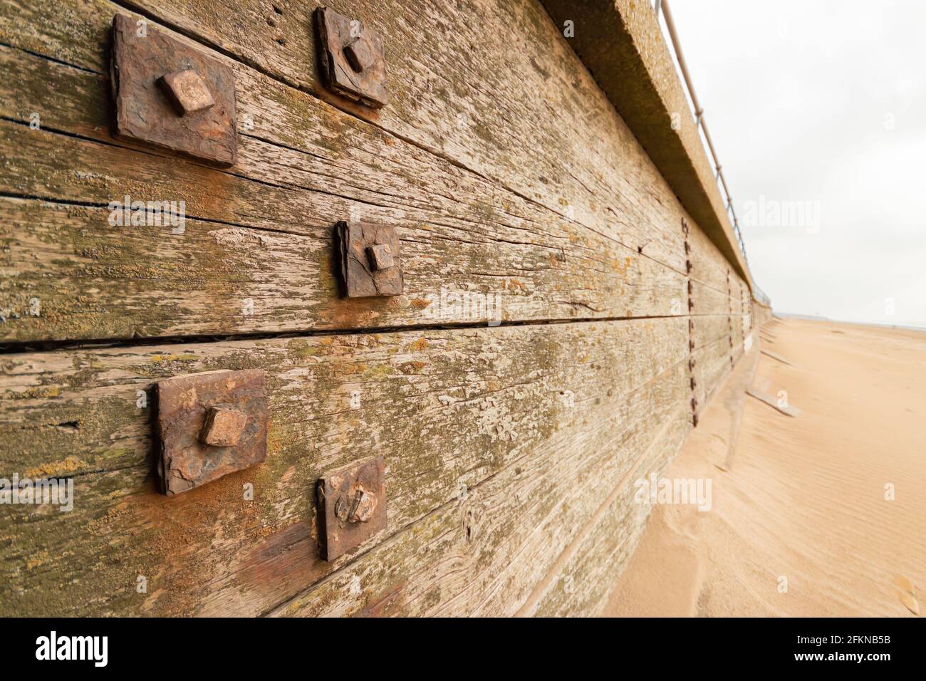 detail of rustic wooden sea defences and groyne at Crosby Beach ...