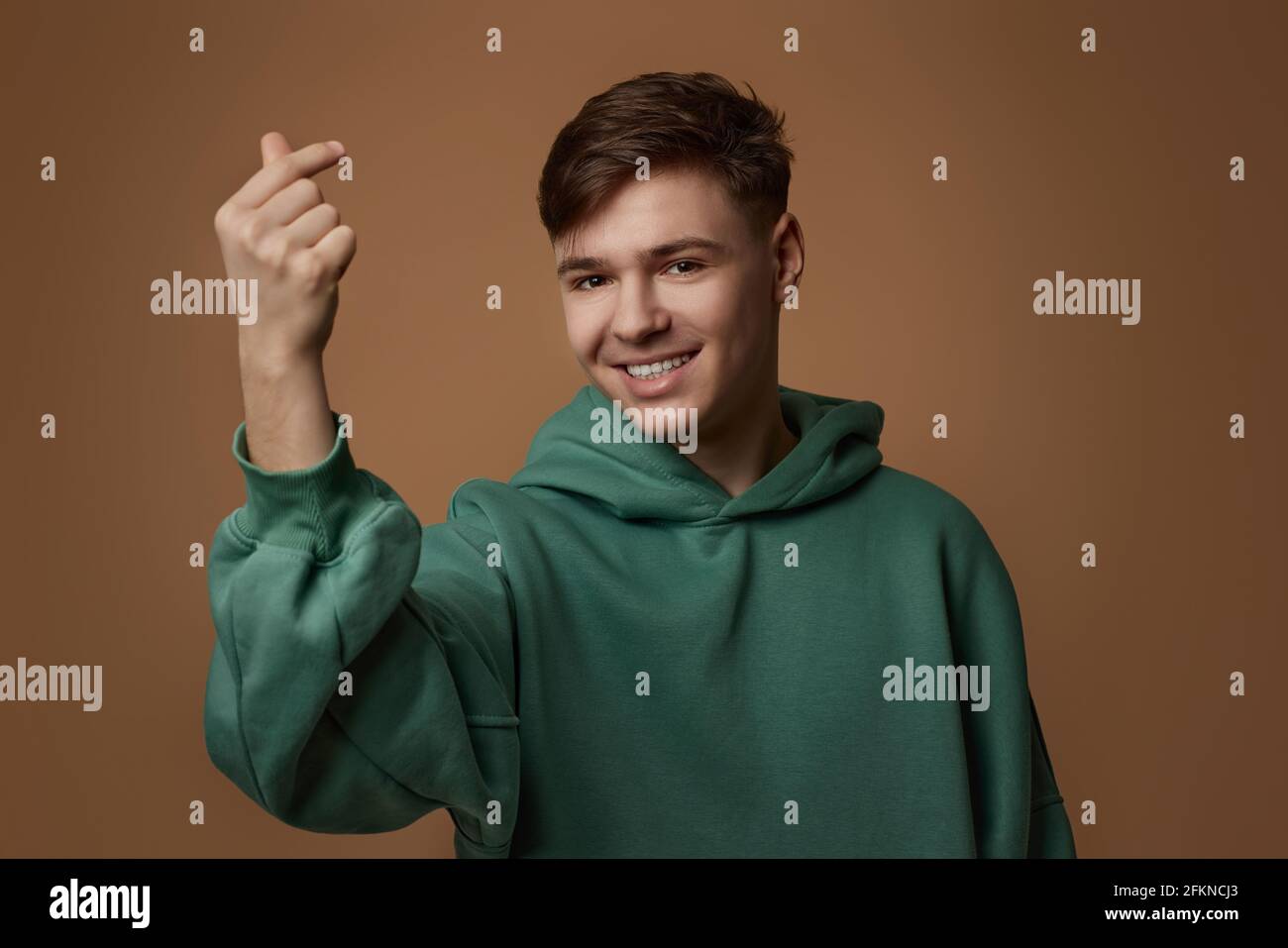 Handsome young man making heart sign with his hands fingers hi-res stock photography and images ...