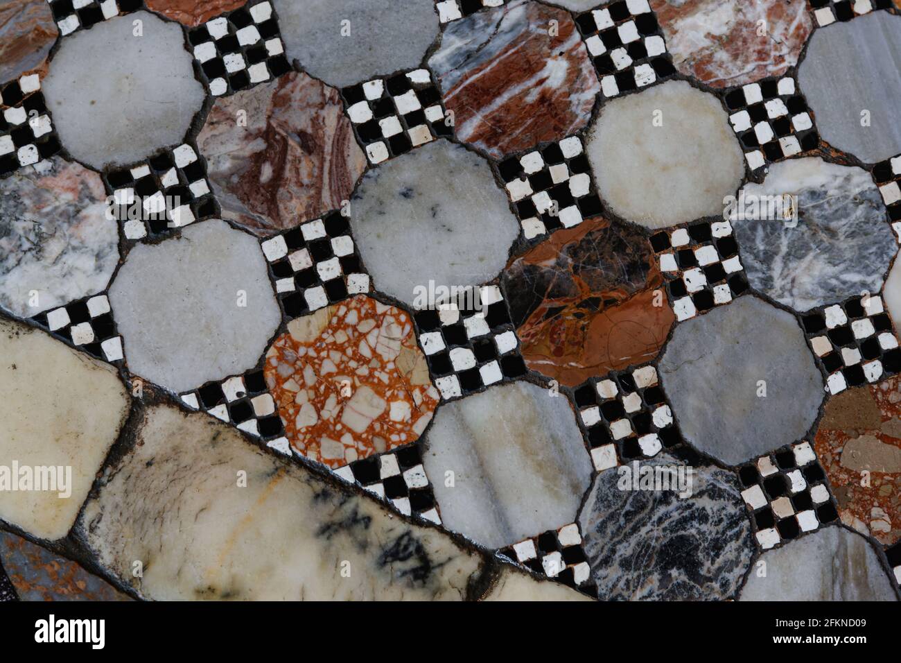 Stone mosaic with polygon and checkered patterns on the floor in ...