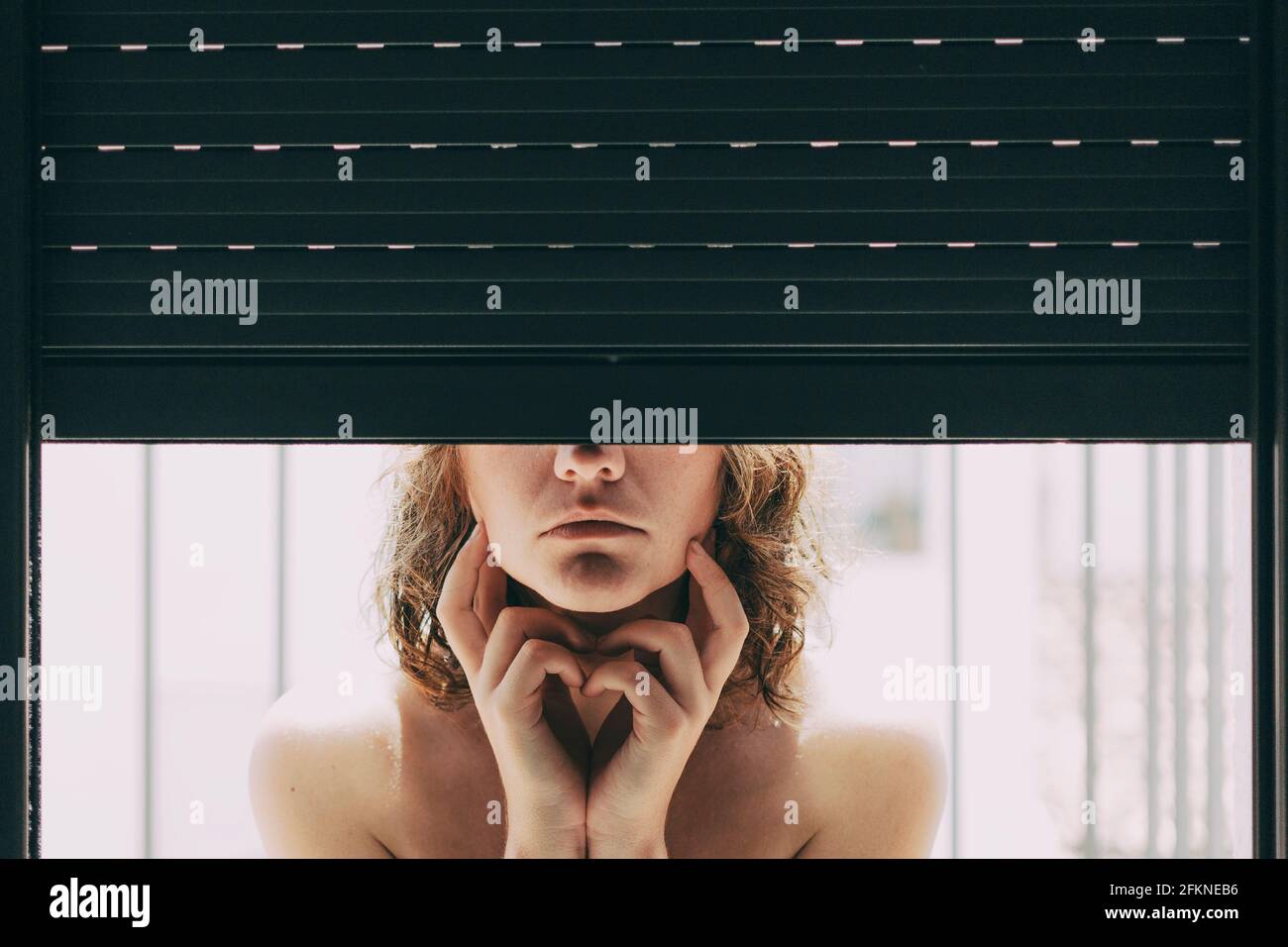 young woman with blue eyes and short hair inside her house, sitting ...