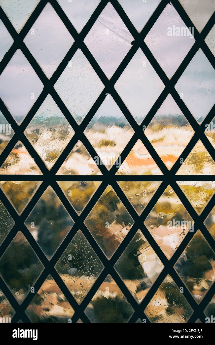 window with a rusty grille with a wrought iron pattern Stock Photo - Alamy