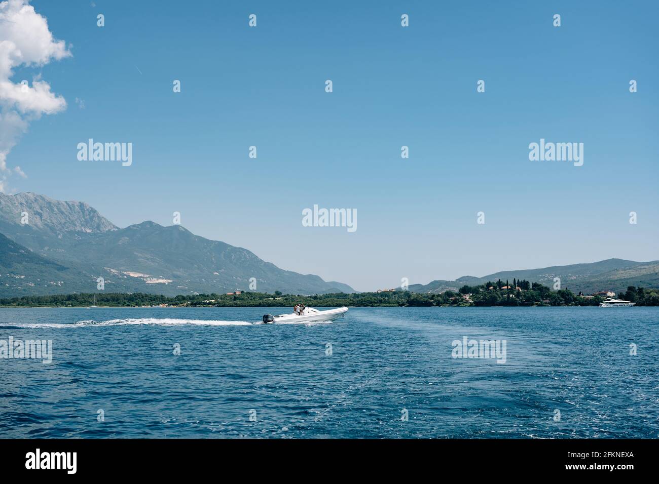 Tourists ride on white. sports boat in the sea against the backdrop of ...