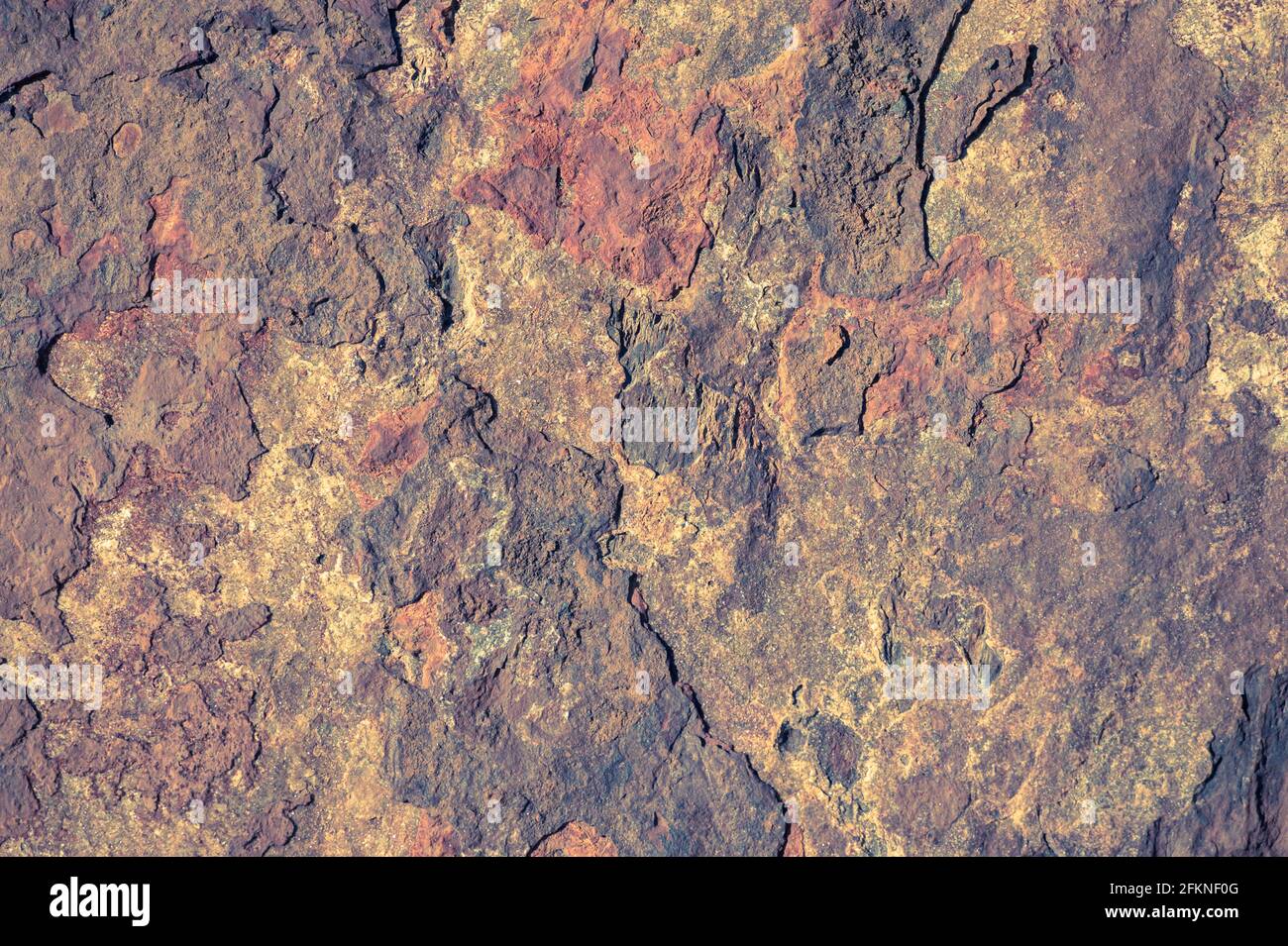 Rough texture of the stone with iron oxides and flaking fragments ...