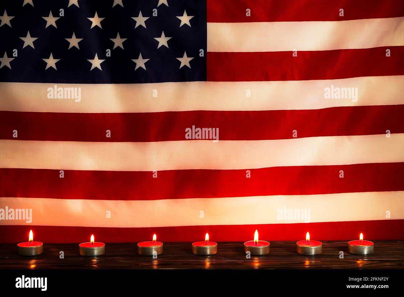 Mourning candles burning on USA American national flag background ...