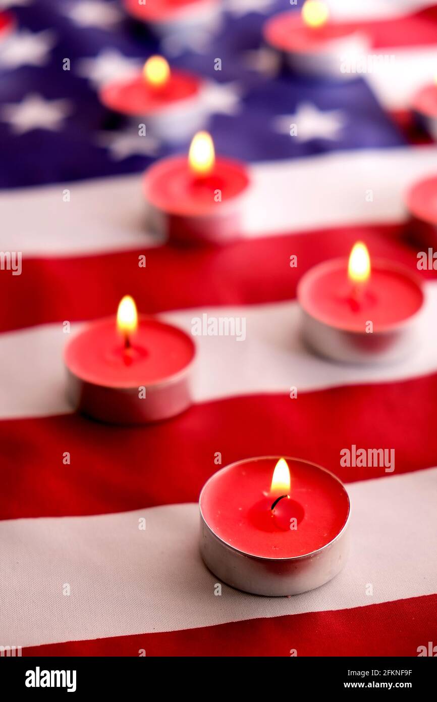 Mourning candles burning on USA American national flag background ...