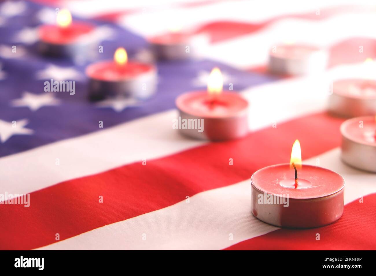 Mourning candles burning on USA American national flag background ...