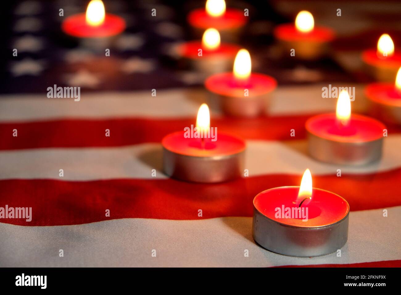 Mourning candles burning on USA American national flag background ...