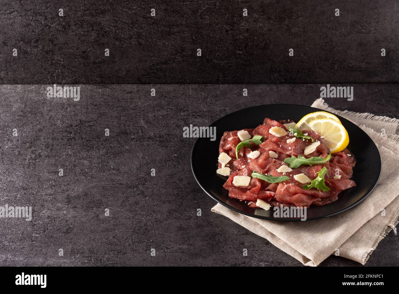 Marbled beef carpaccio on black slate background Stock Photo - Alamy