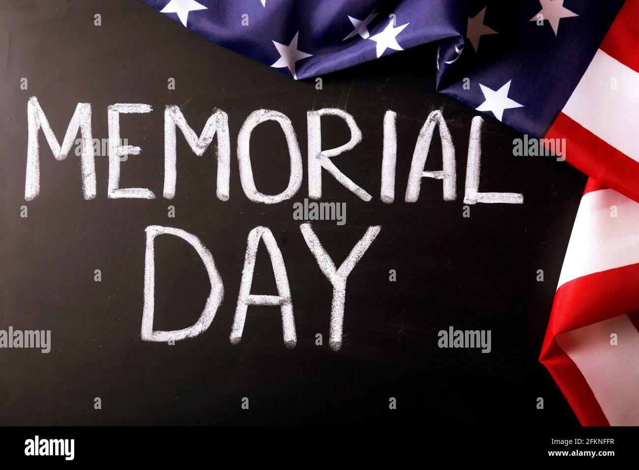 Memorial day weekend text written on wooden black chalkboard with USA ...