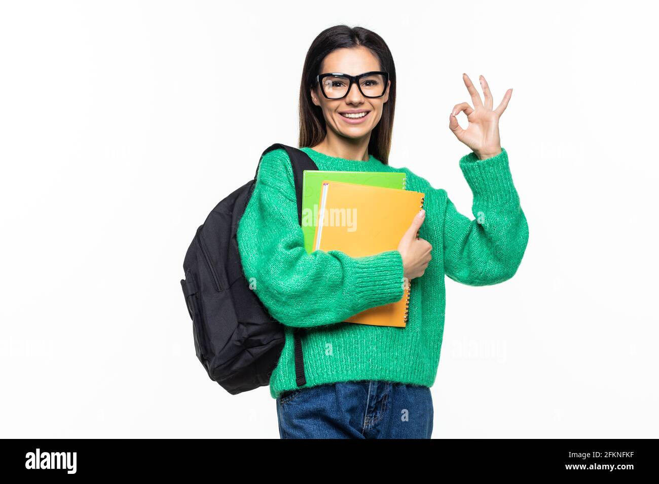 Portrait of a beautiful young student woman showing okay isolated on ...