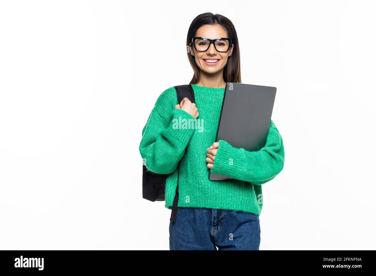 Smiling female student holding laptop and looking at camera isolated on ...