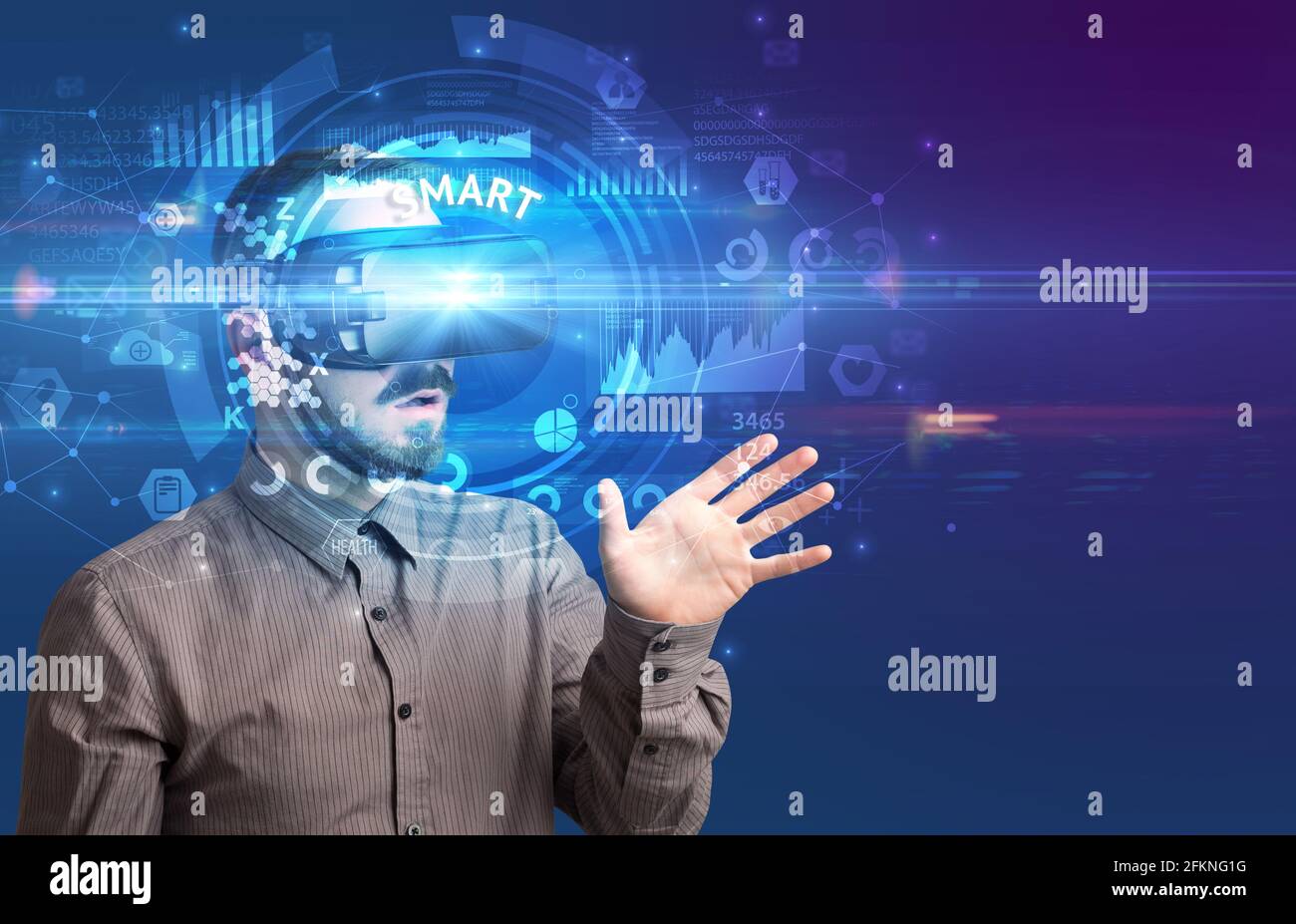Businessman looking through VR glasses Stock Photo - Alamy